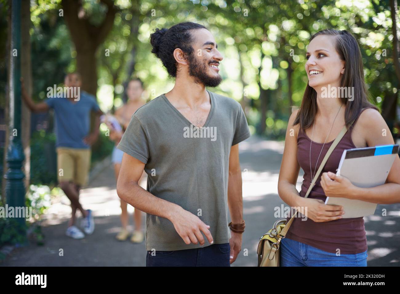 Campus conversations. a college students hanging out on campus Stock ...