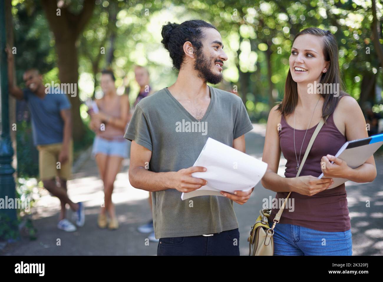 Going over some notes on the way to class. a male and female student on ...