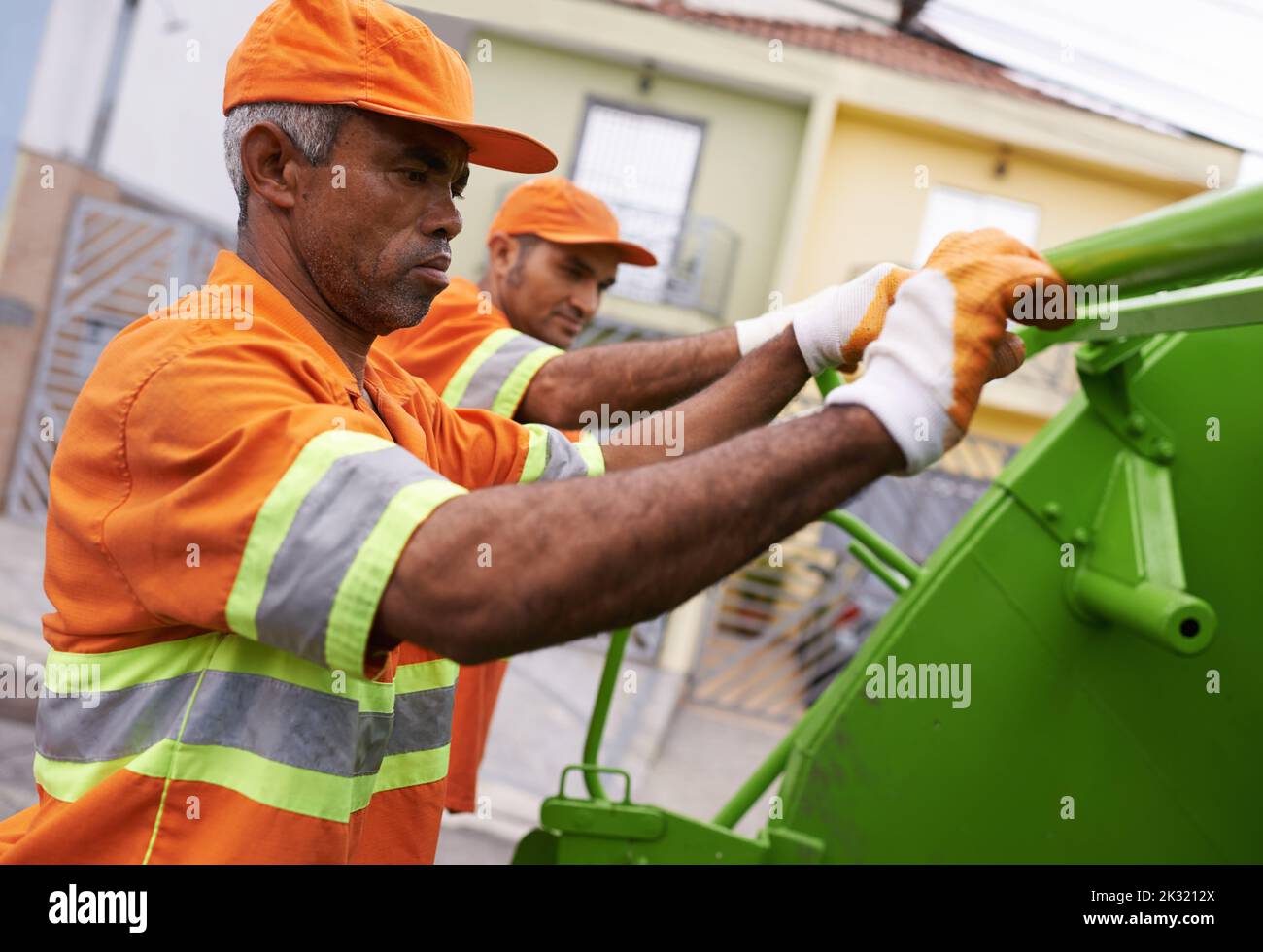 Keeping the city clean. a team of garbage collectors Stock Photo - Alamy