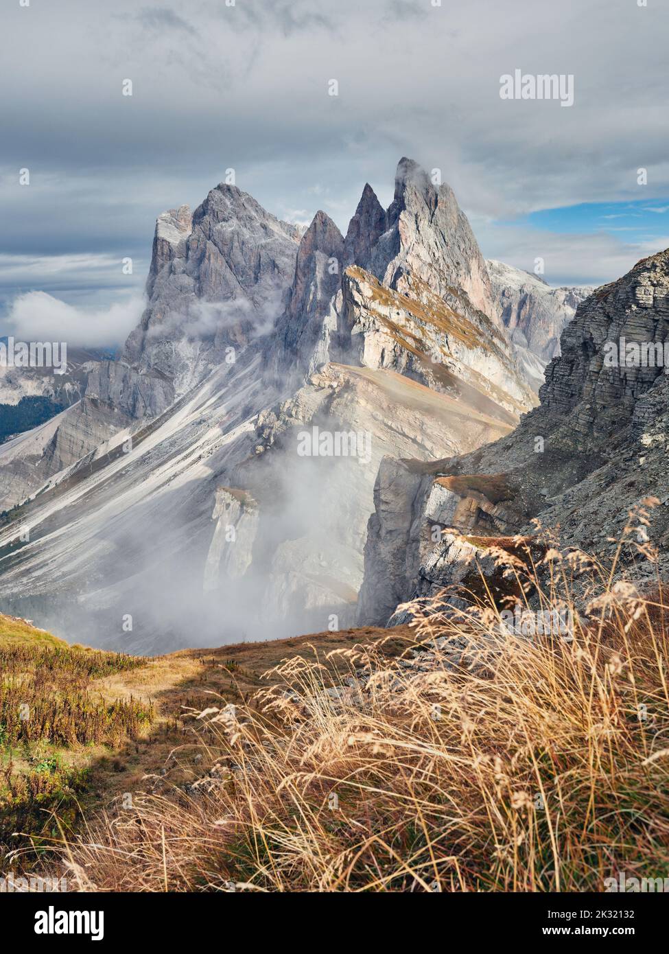 An aerial view of Dolomites mountain landscape under blue bright sky ...