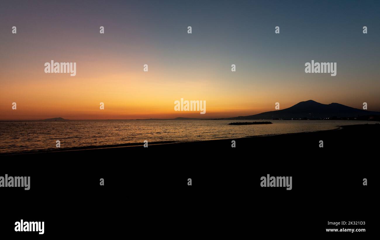 A beautiful scene of dark orange sunset sky and silhouette Mount ...