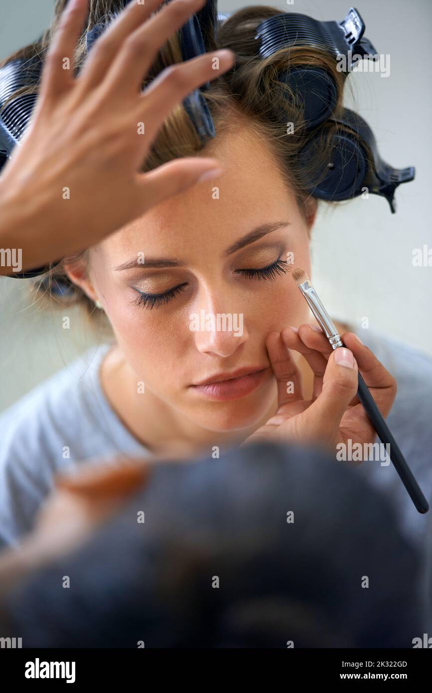 Perfecting her look. A beautiful young woman spending the day getting ...