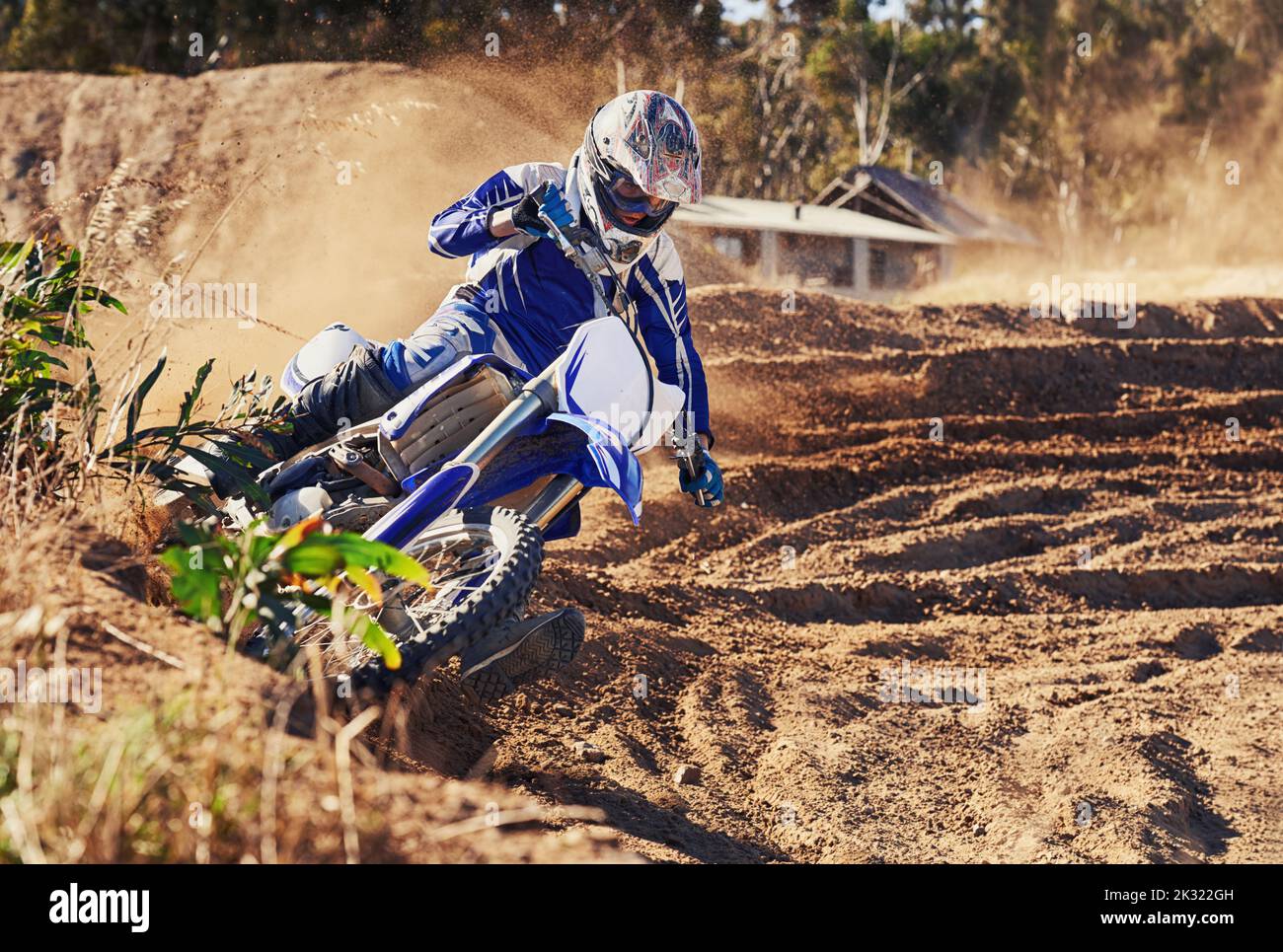 Time to rip up this track. a motocross rider broadsiding a corner Stock ...