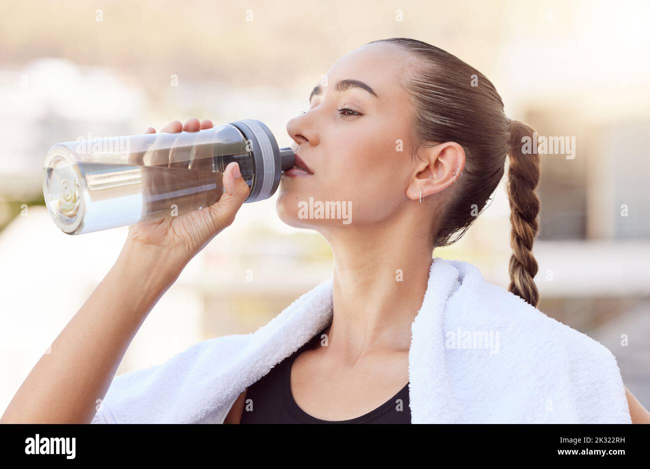 Fitness, exercise and drinking water with woman after workout training ...
