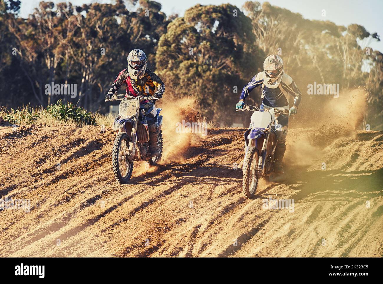 Time to rip up this track. a two motocross riders racing with a trial ...