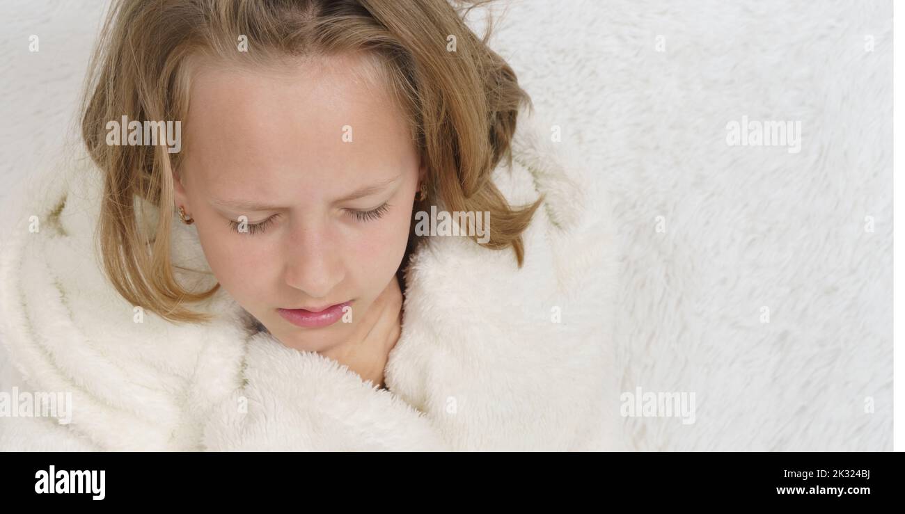 Sick teenage girl holds hand to sore throat. Colds, tonsillitis ...