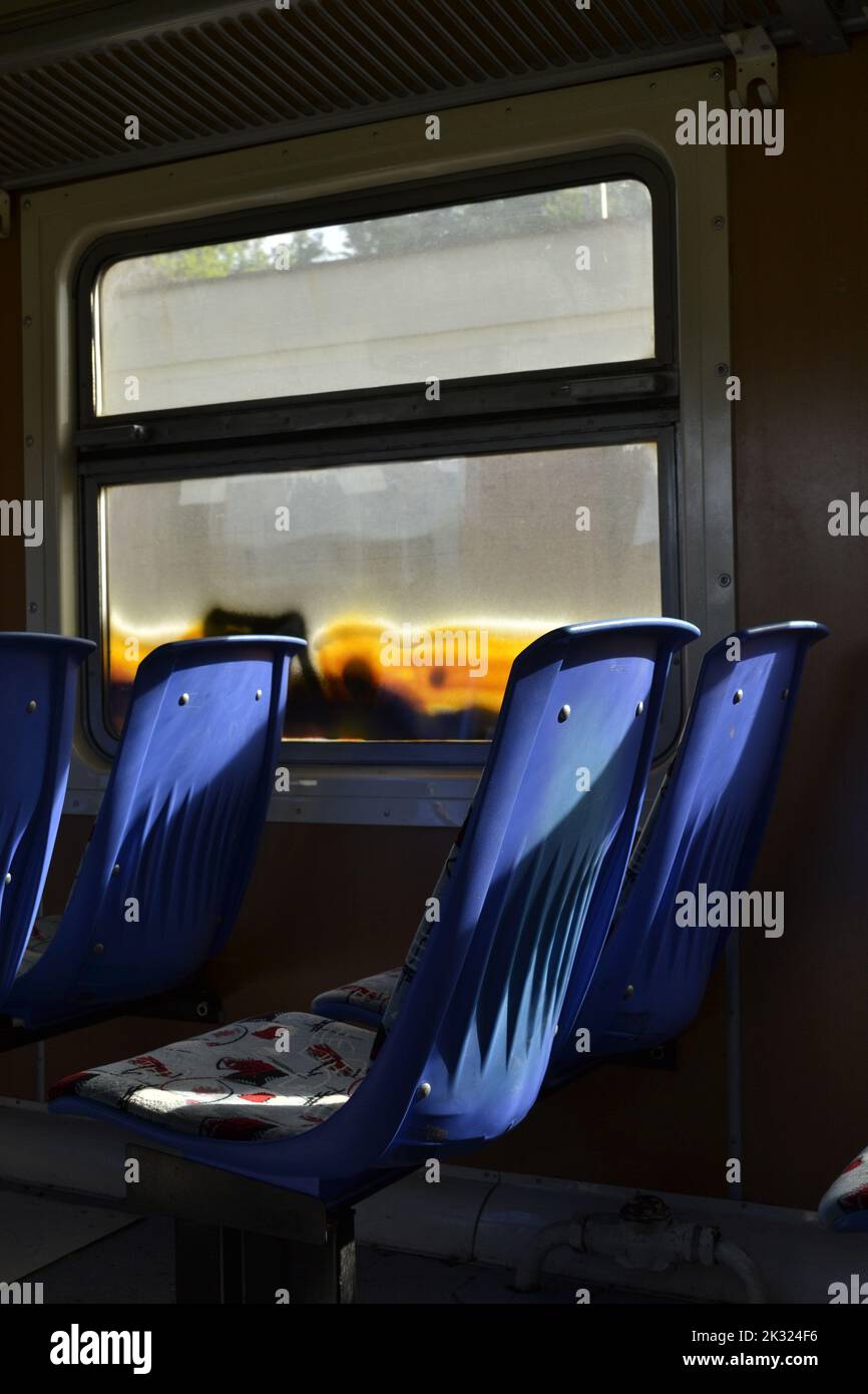 A plastic blue seat in a train car. A plastic blue seat in a train ...