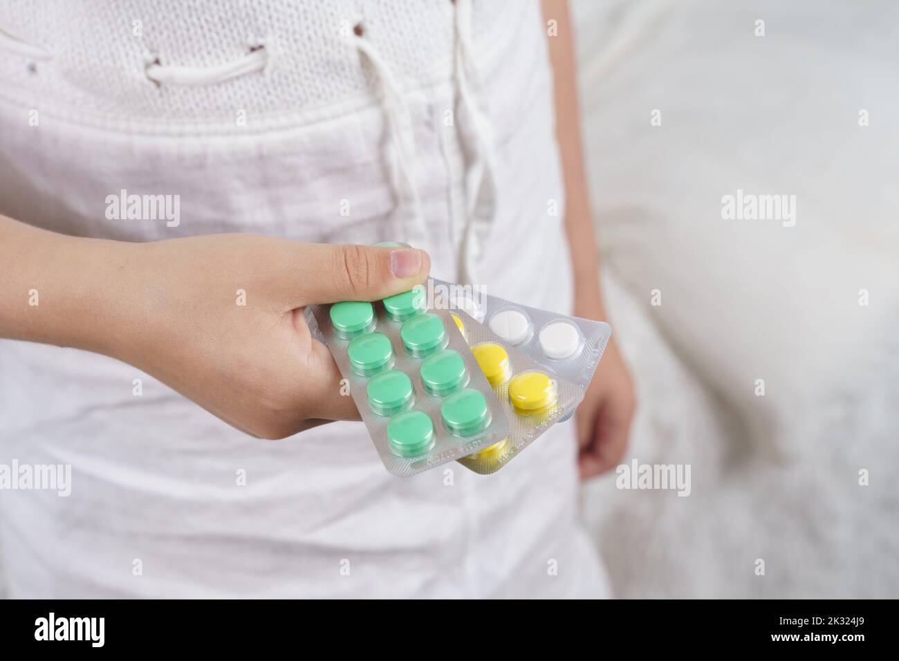 Sick teenage girl spills pills on her hand. Medical concept Stock Photo ...