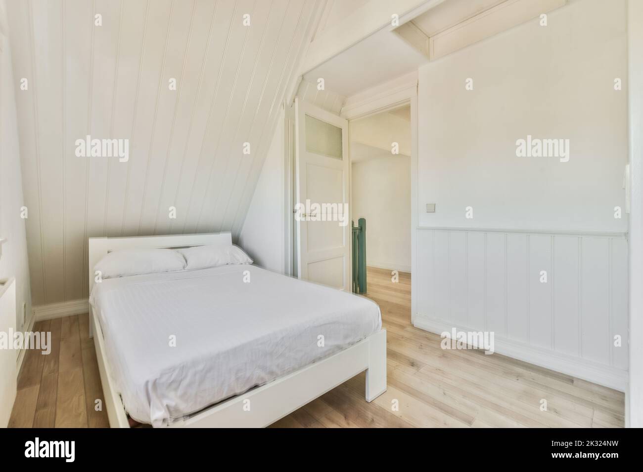 Modern home interior design of small mansard bedroom with white walls ...