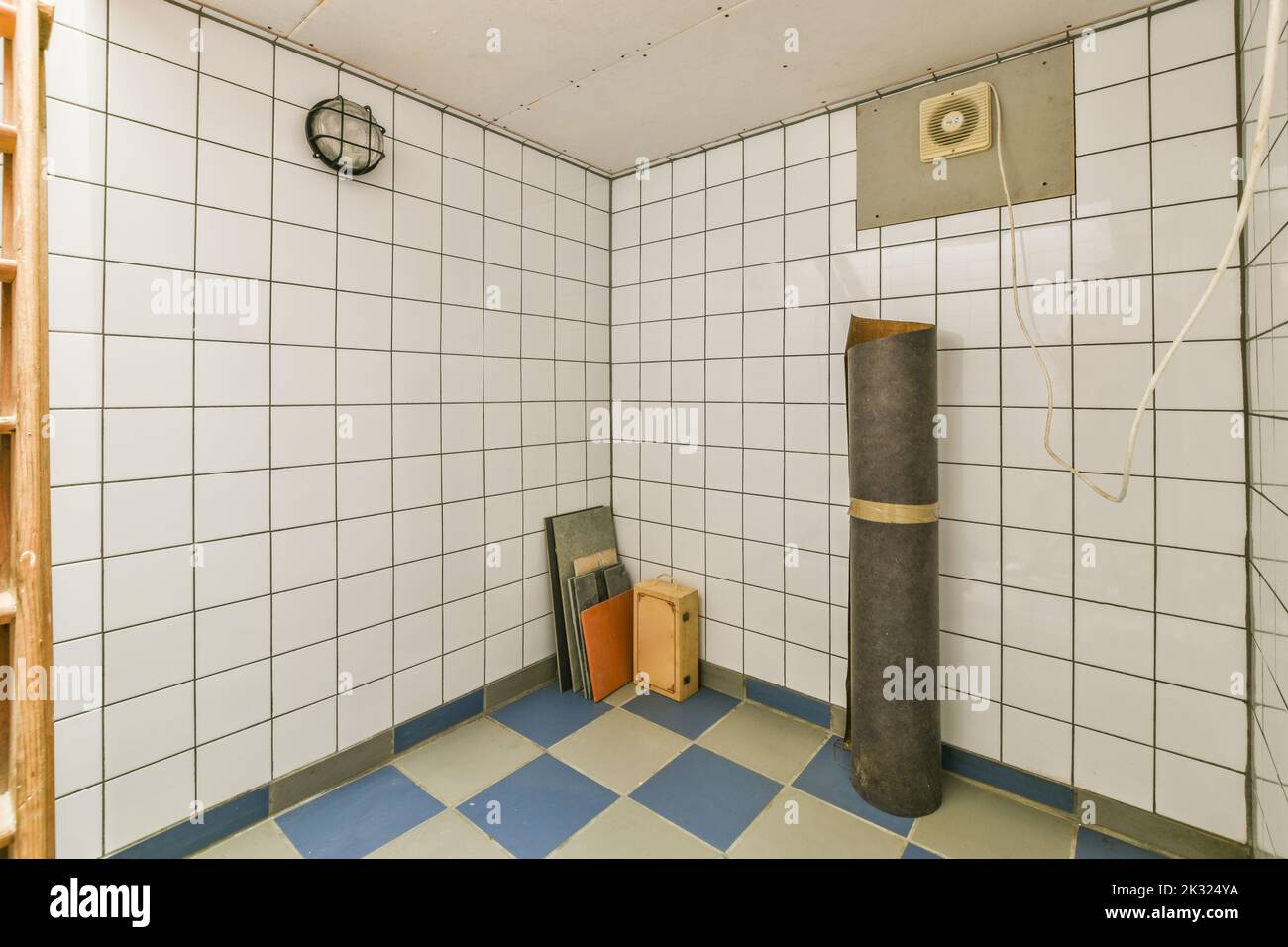 cupboard near doors in spacious room with tile walls and tile floor ...