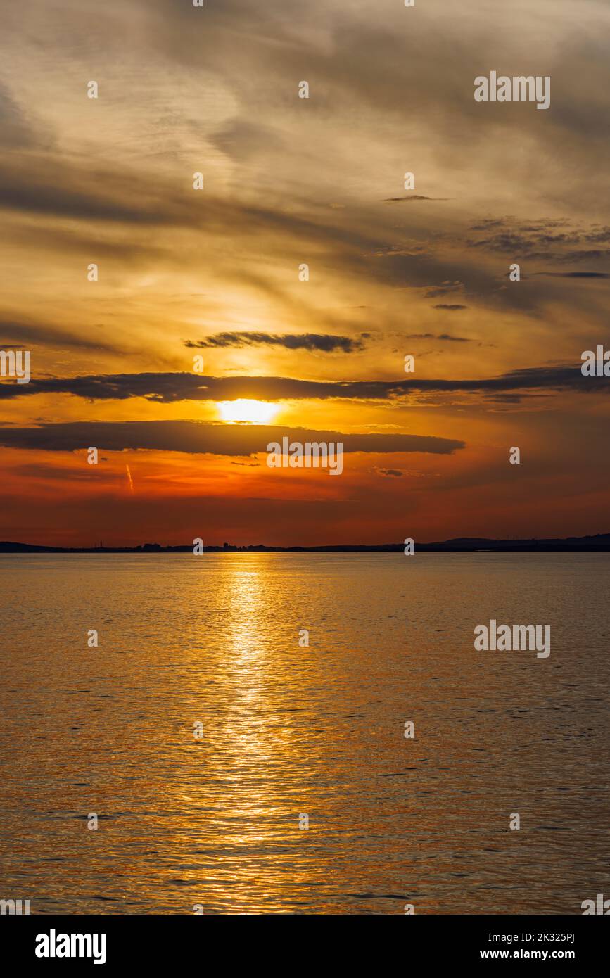 The setting sun lighting up the horizon Stock Photo - Alamy