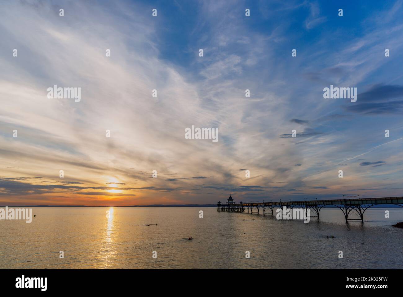 The setting sun lighting up the horizon Stock Photo - Alamy