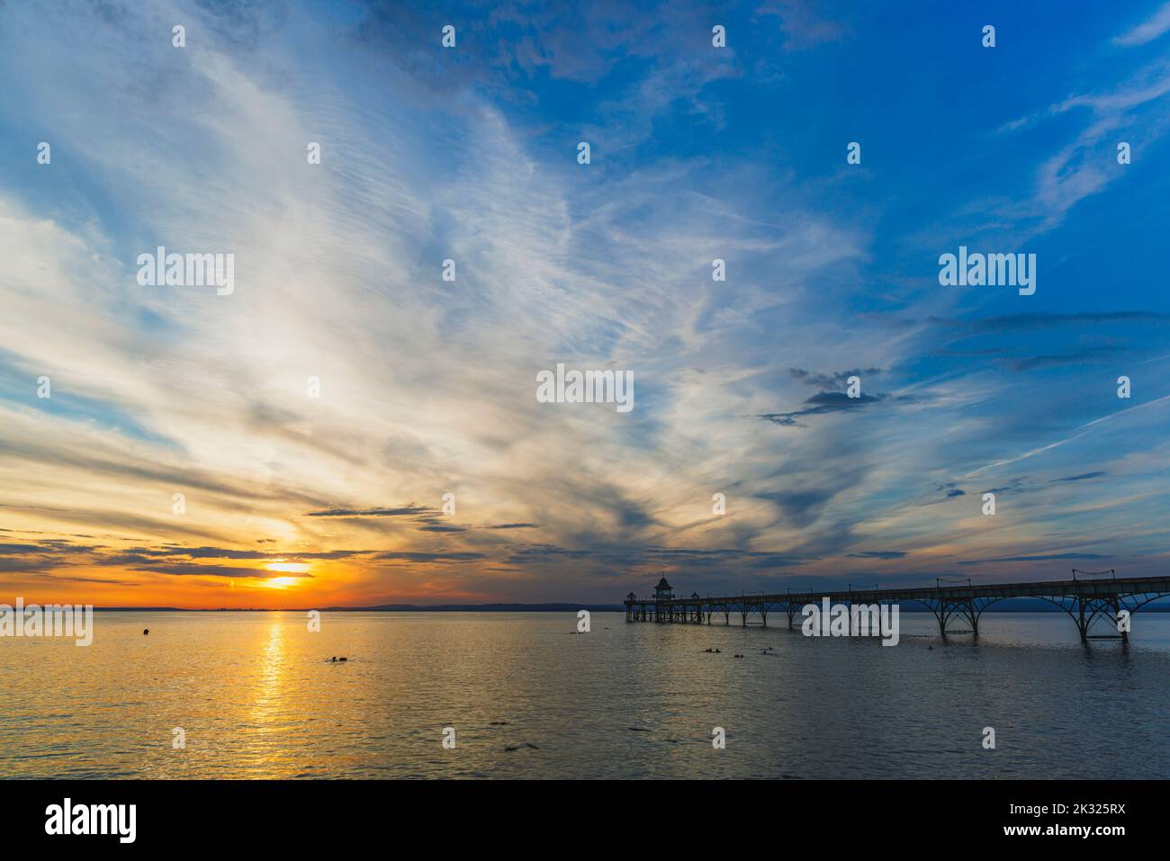 The setting sun lighting up the horizon Stock Photo - Alamy