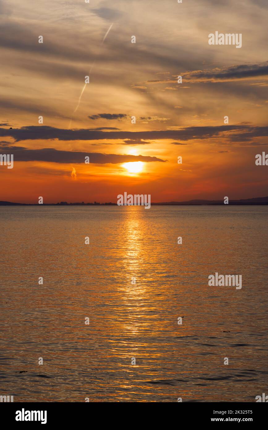 The setting sun lighting up the horizon Stock Photo - Alamy