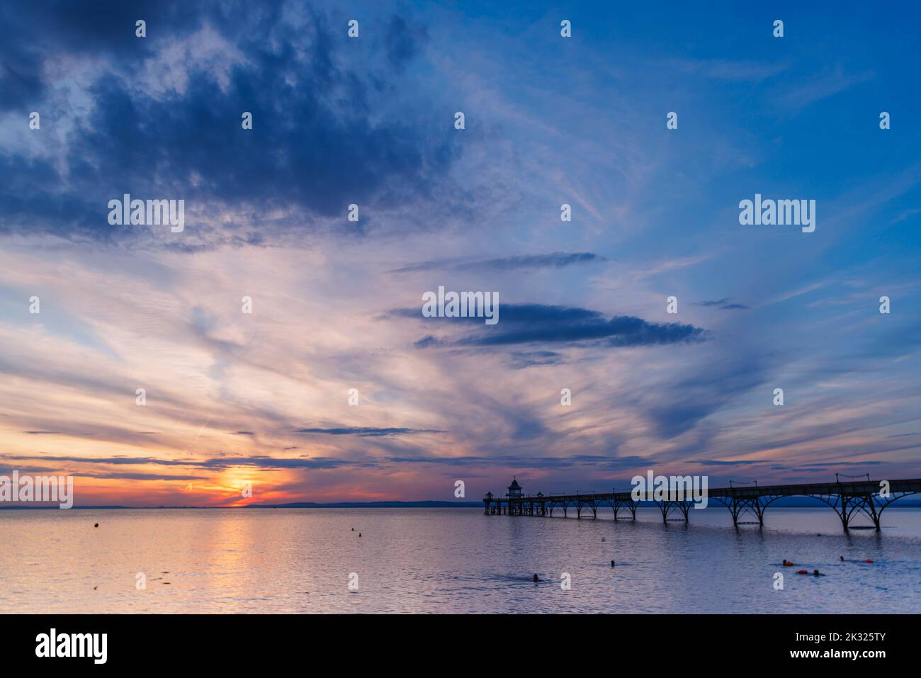 The setting sun lighting up the horizon Stock Photo - Alamy