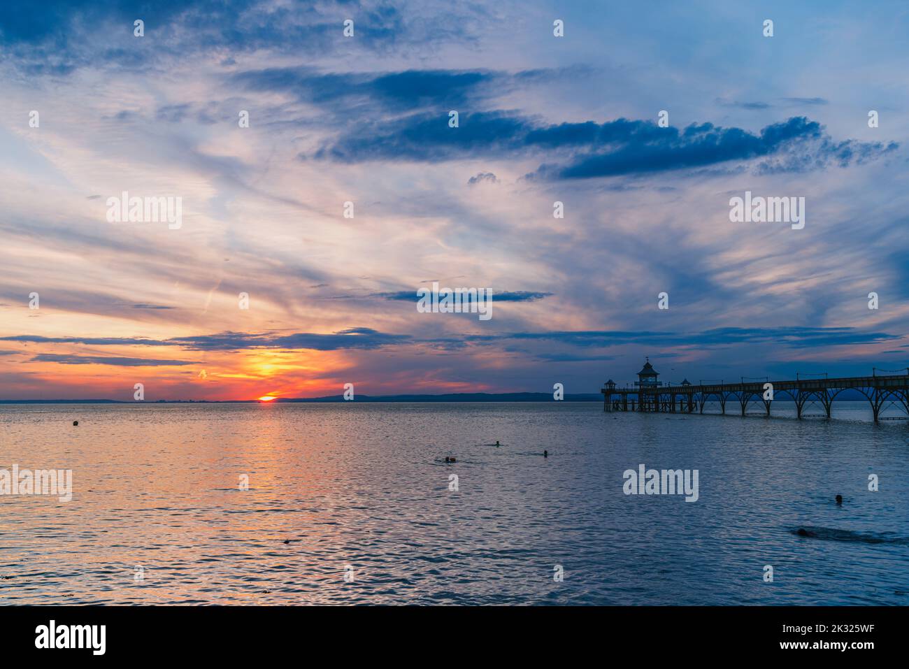 The setting sun lighting up the horizon Stock Photo - Alamy