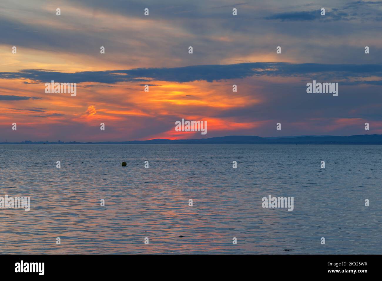 The setting sun lighting up the horizon Stock Photo - Alamy