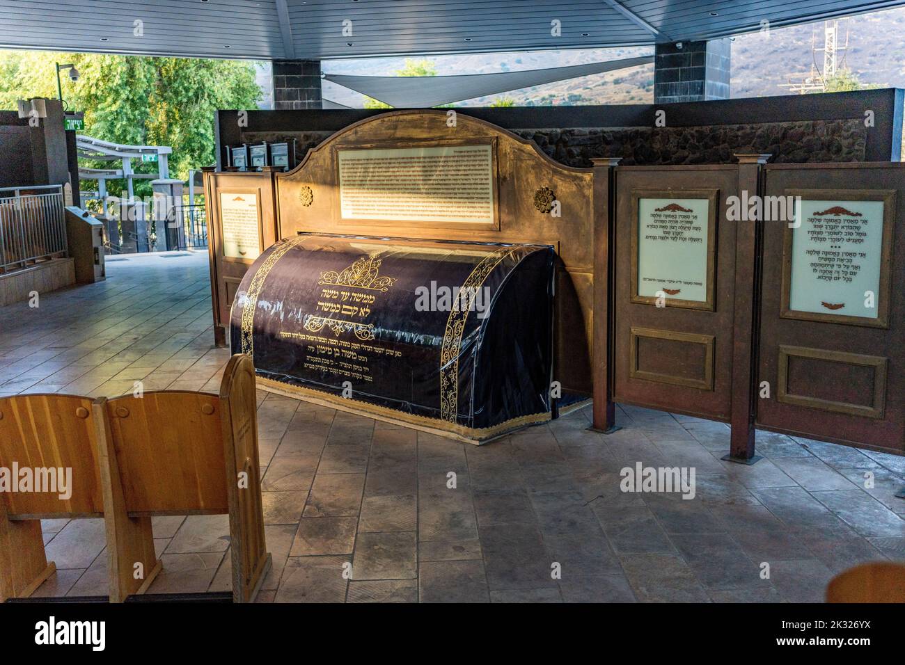 An inside view of the tomb of Maimonides with wooden chairs and a ...
