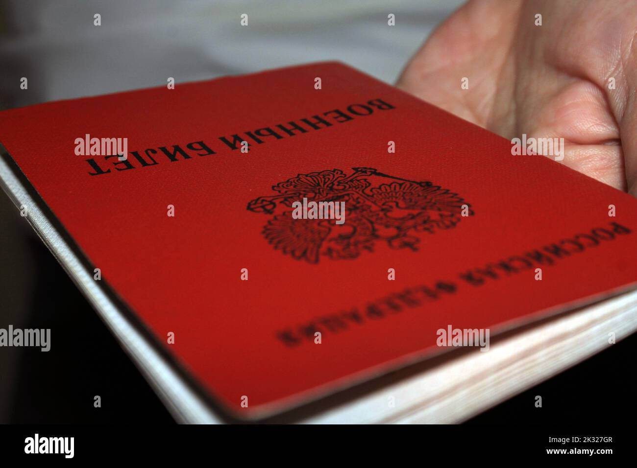 Military ID issued by the Russian Federation, close-up of a man holding ...