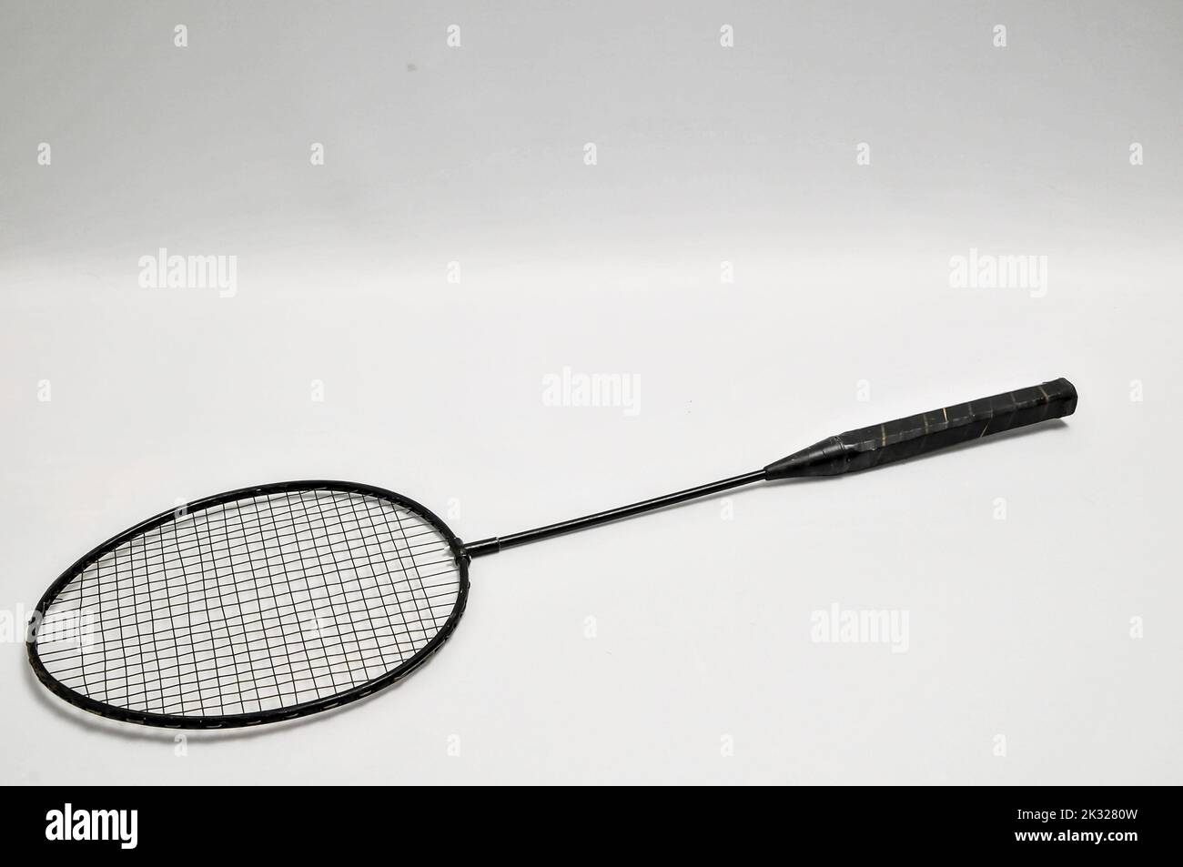 A black badminton racket isolated on white background Stock Photo - Alamy