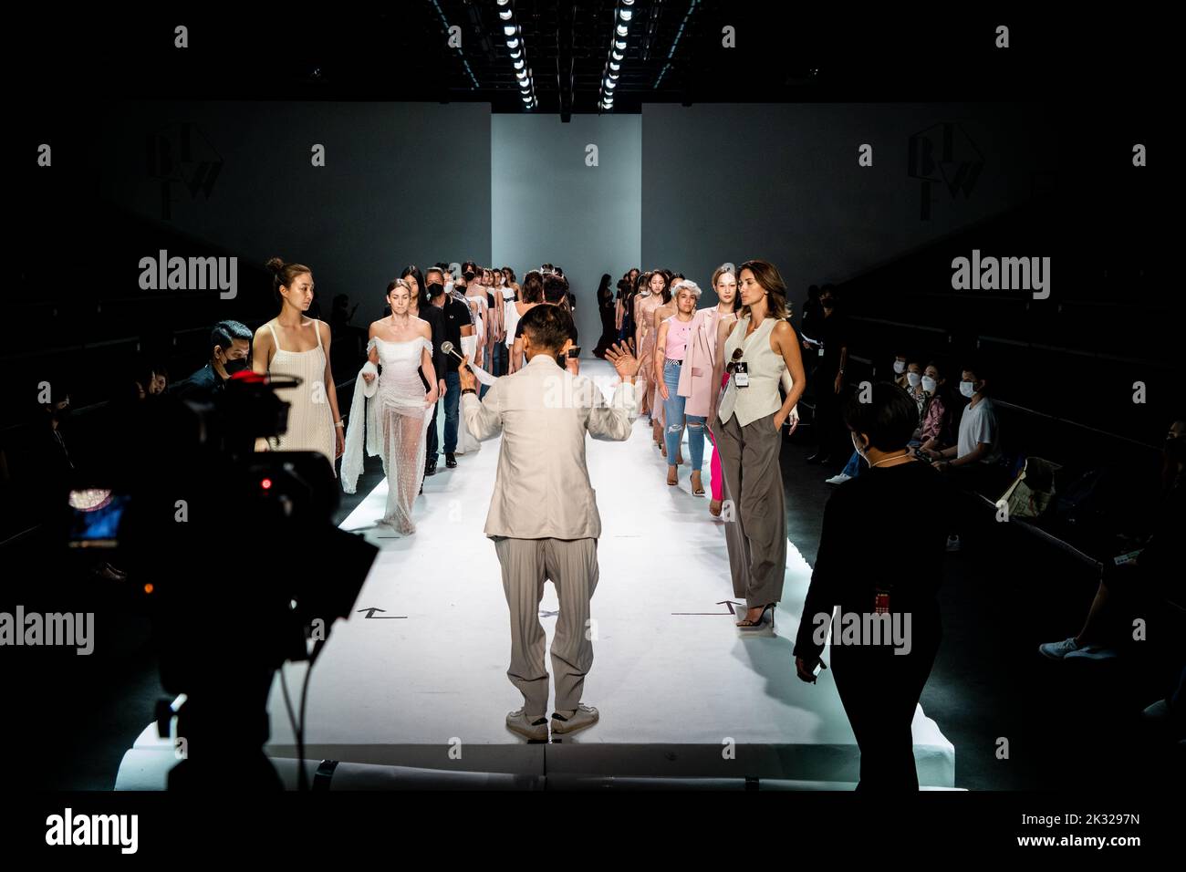 Models take instruction from a director as they rehearse before the ...