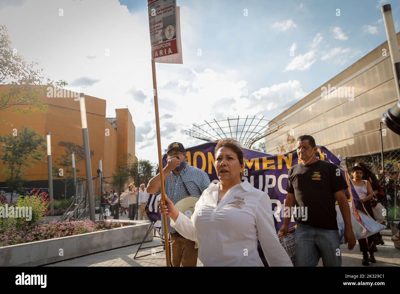 Protesters march towards the entrance of the shopping center during a ...