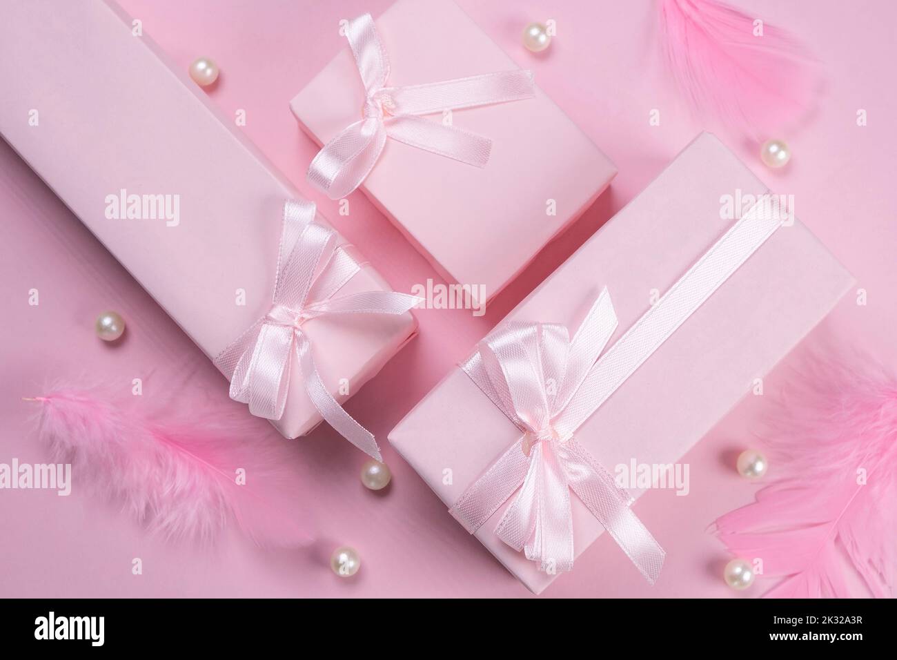 pink gift boxes with pink bows on a pink background decorated with ...