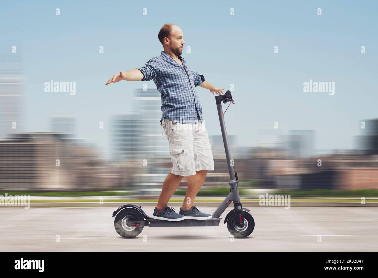 Careless man riding an electric scooter hands free, he is balacing with ...