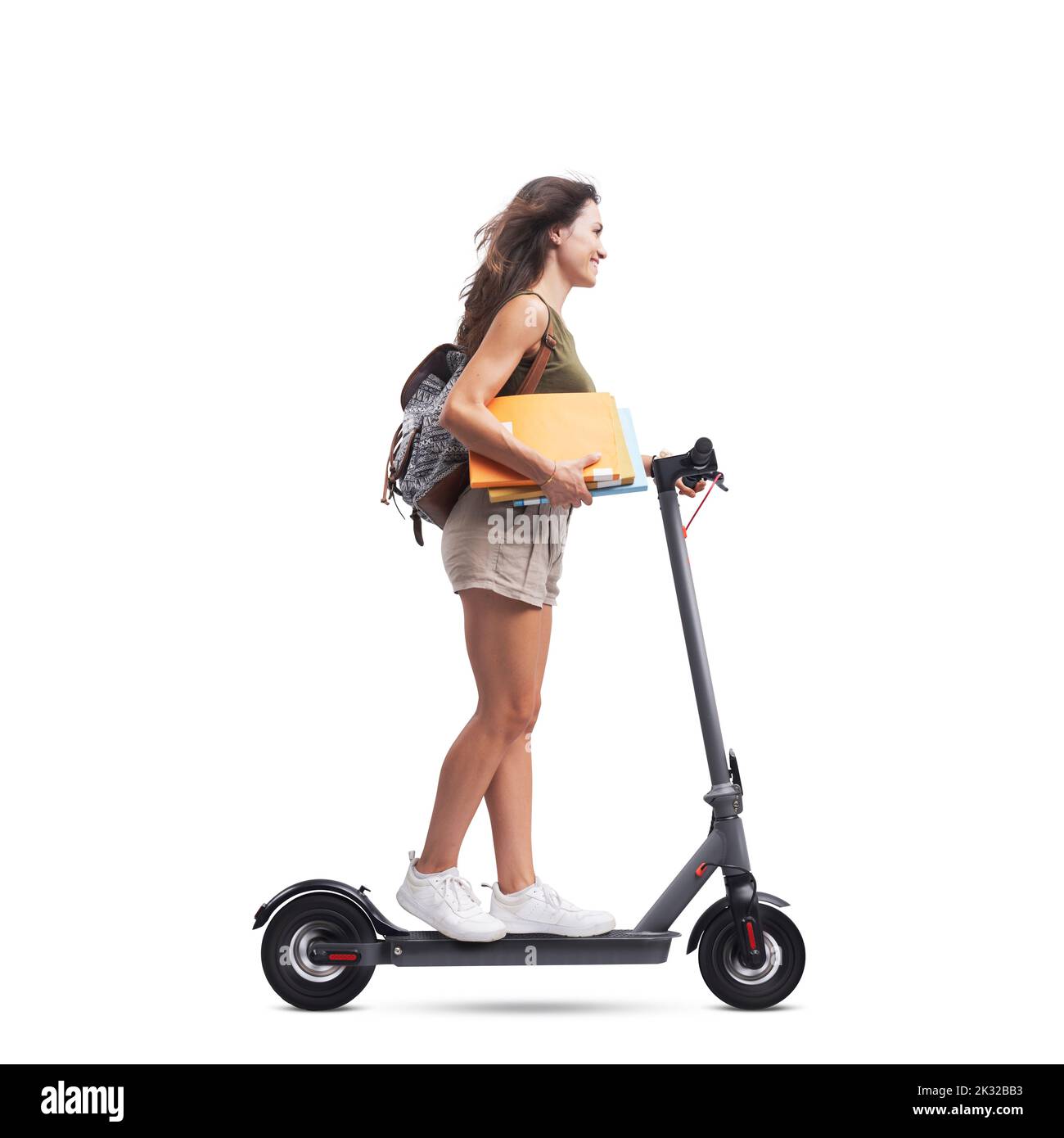Smiling student with backpack riding an eco-friendly electric scooter ...