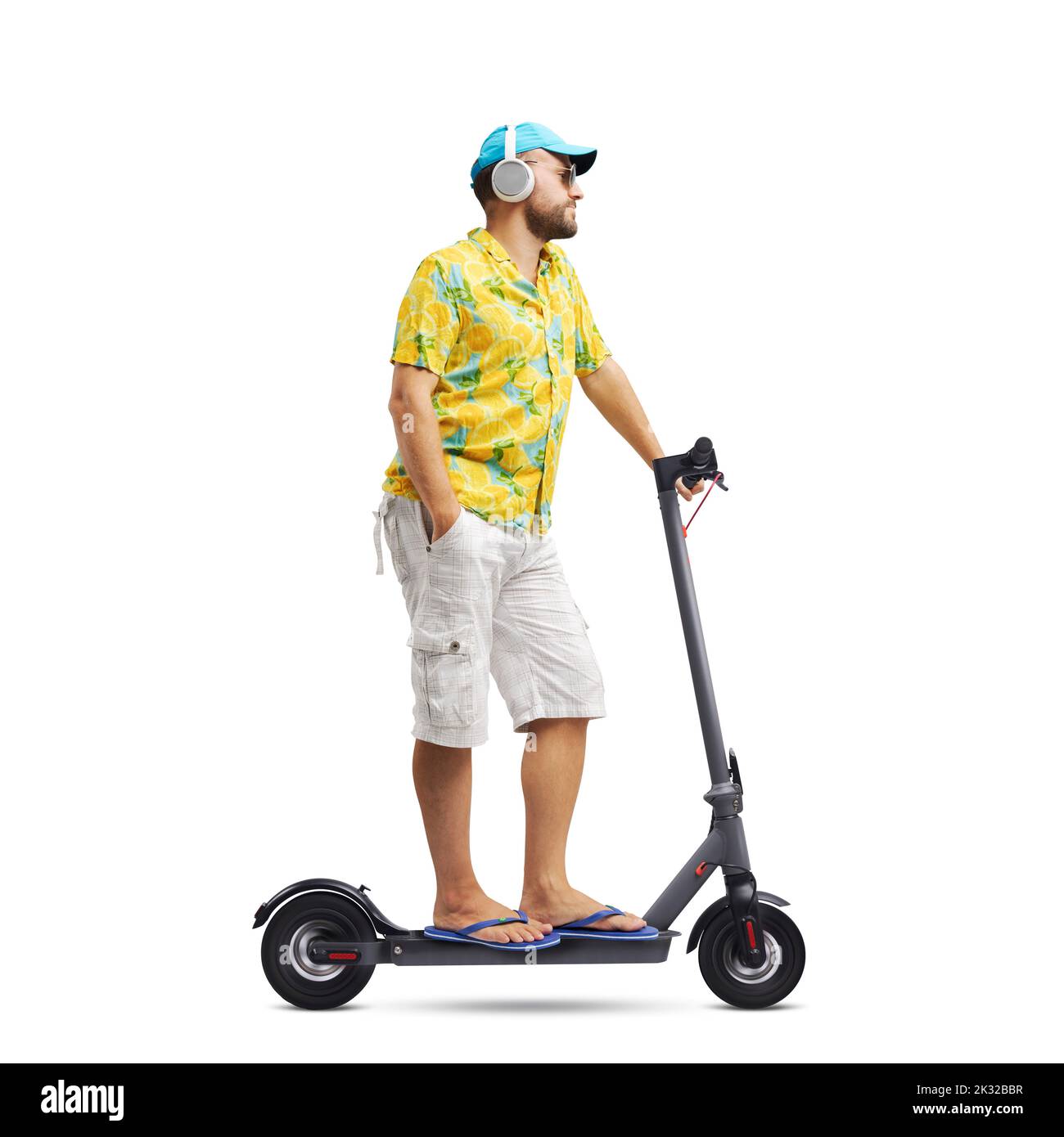 Cool stylish man wearing a colorful beach shirt and riding a fast eco ...