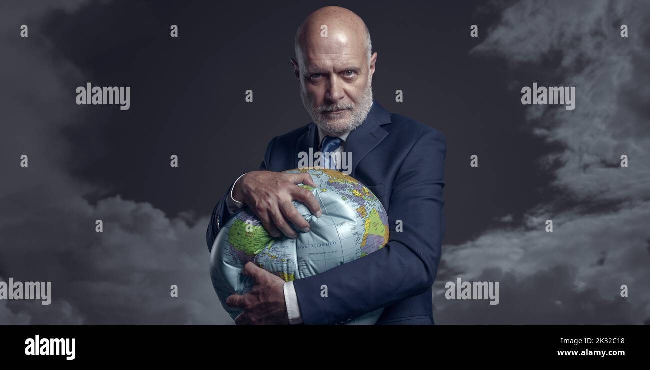 Greedy corporate businessman crushing a globe: earth exploitation and ...