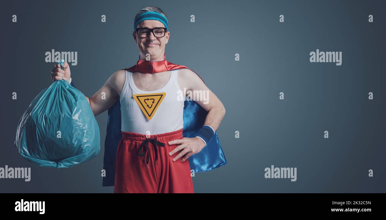 Smiling funny eco-friendly superhero holding a trash bag: recycling ...