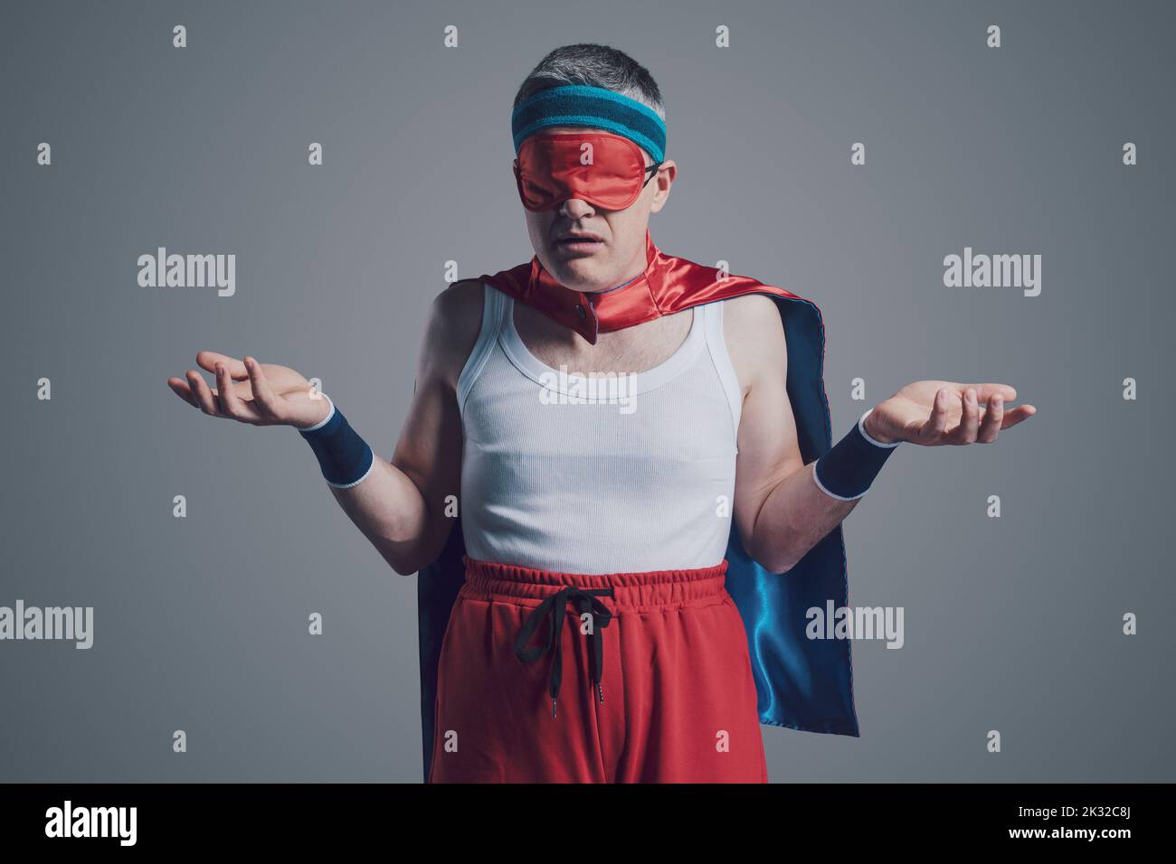 Funny clueless superhero wearing a sleep mask over his eyes and ...