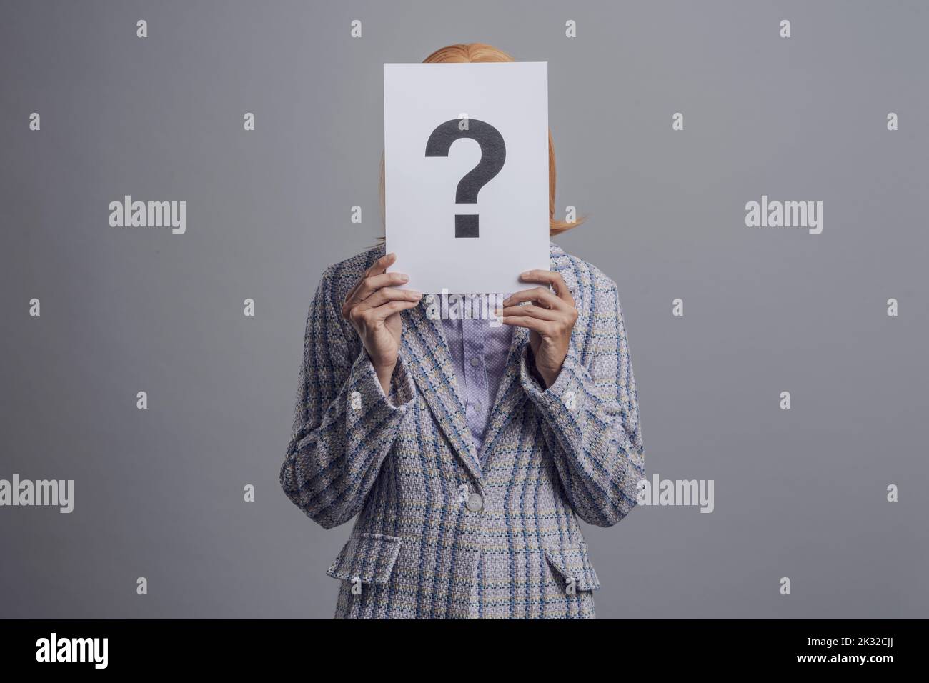 Businesswoman hiding behind a sign with question mark Stock Photo - Alamy