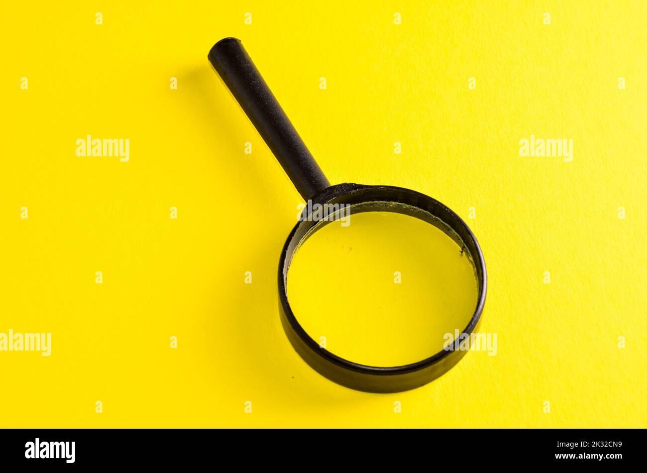 A magnifying glass on the yellow background Stock Photo - Alamy