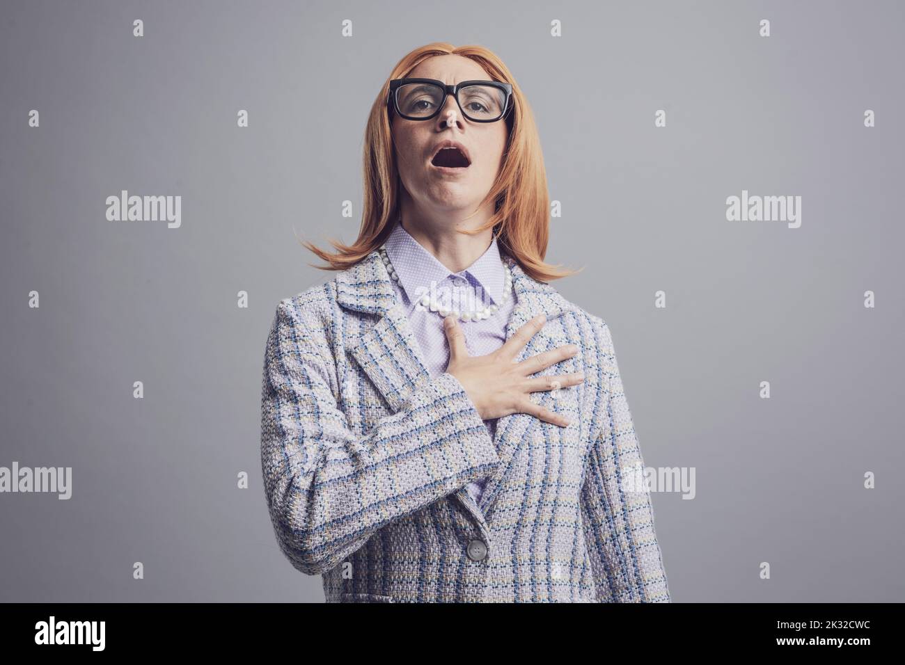 Patriotic woman touching her chest and singing the national anthem ...