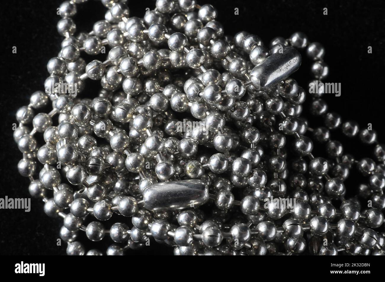 The silver chain on the black background Stock Photo - Alamy