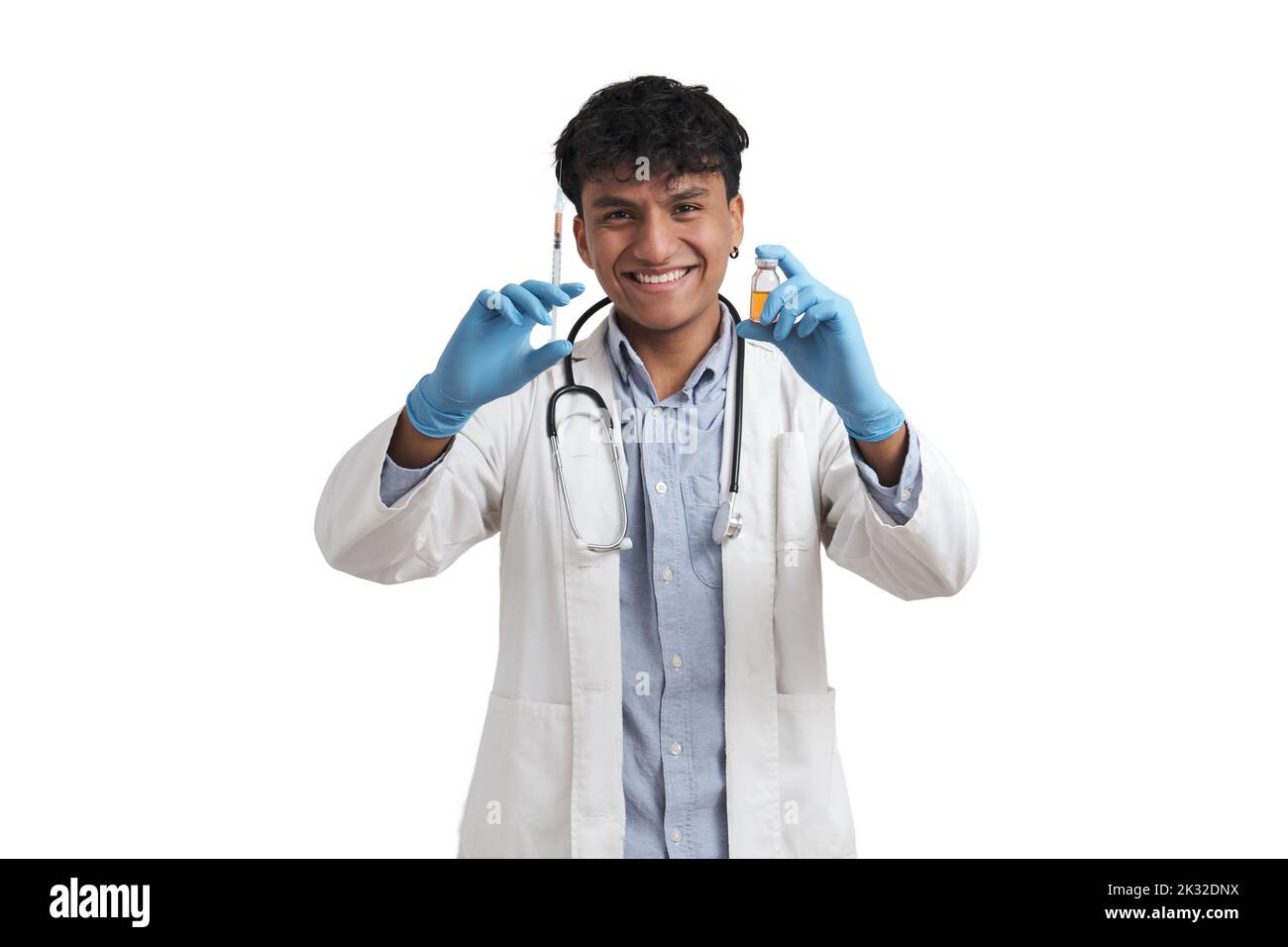 Young peruvian male doctor smiling holding a syringe and a vial ...