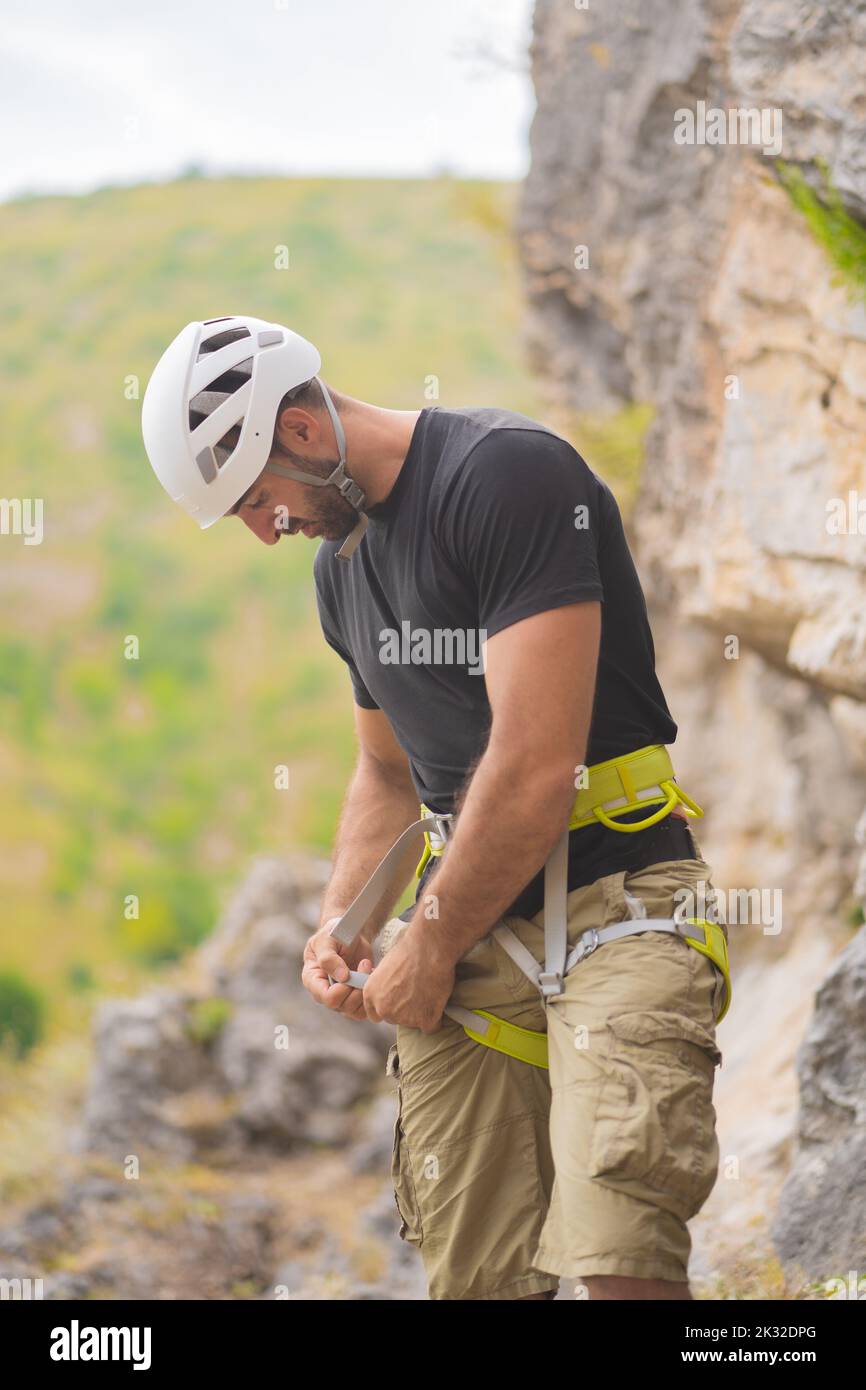 Fit and handsome guy is geting ready to climb the high hill Stock Photo ...