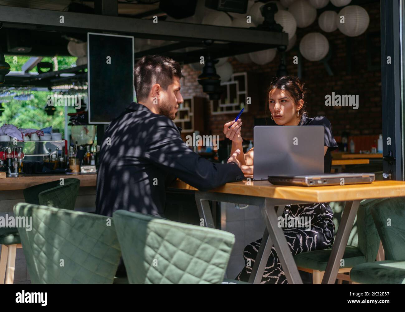 Lovely businesswoman is trying to help her male partner to figure a ...