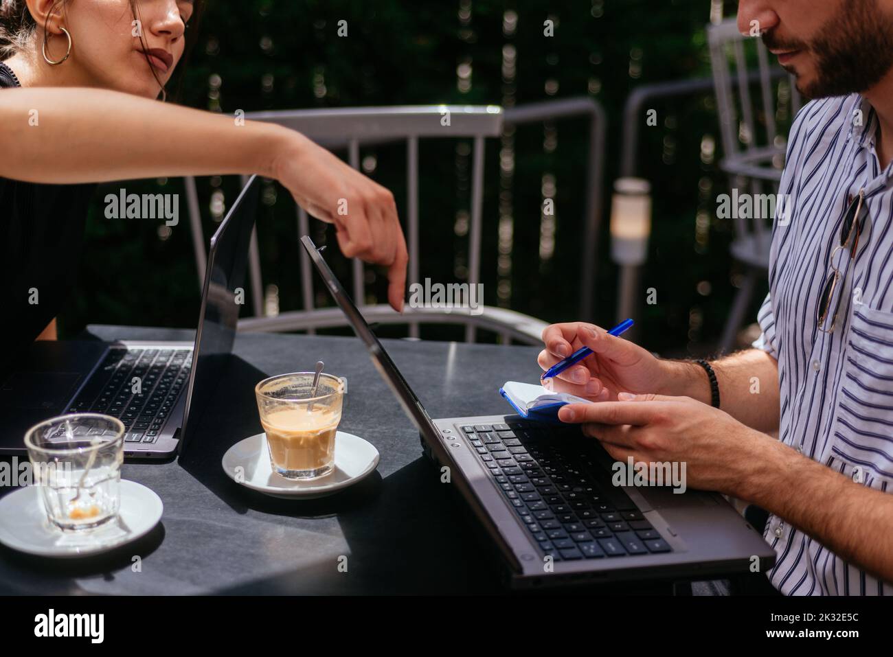 A young beautiful businesswoman is trying to help to her male colleague ...