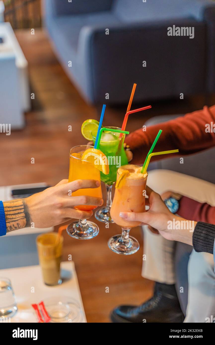 Three colourful cocktails in the middle of the picture, close up Stock ...