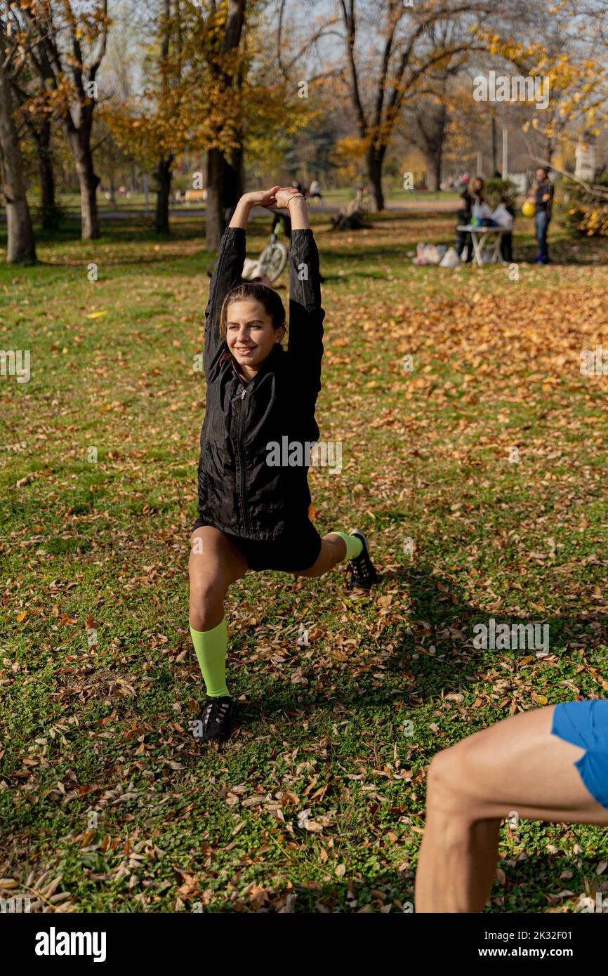 Three attractive and amazing fit friends are stretching and smiling ...