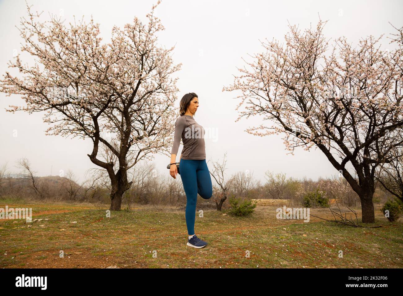 Girl is stretching her leg in nature Stock Photo - Alamy
