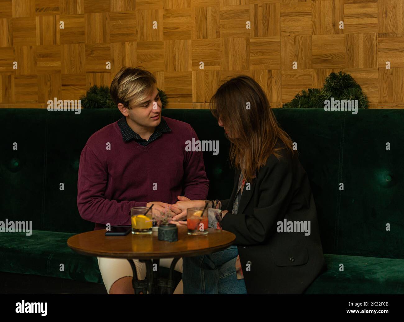 Attractive and amazing boyfriend is talking while holding her hand ...
