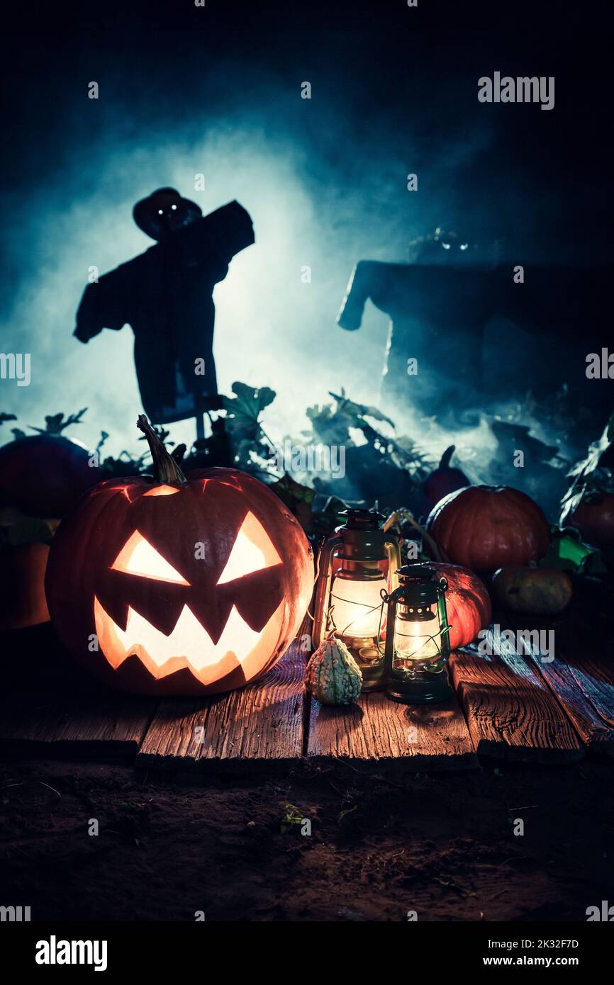 Halloween pumpkin with blue mist and scarecrows at night. Background ...