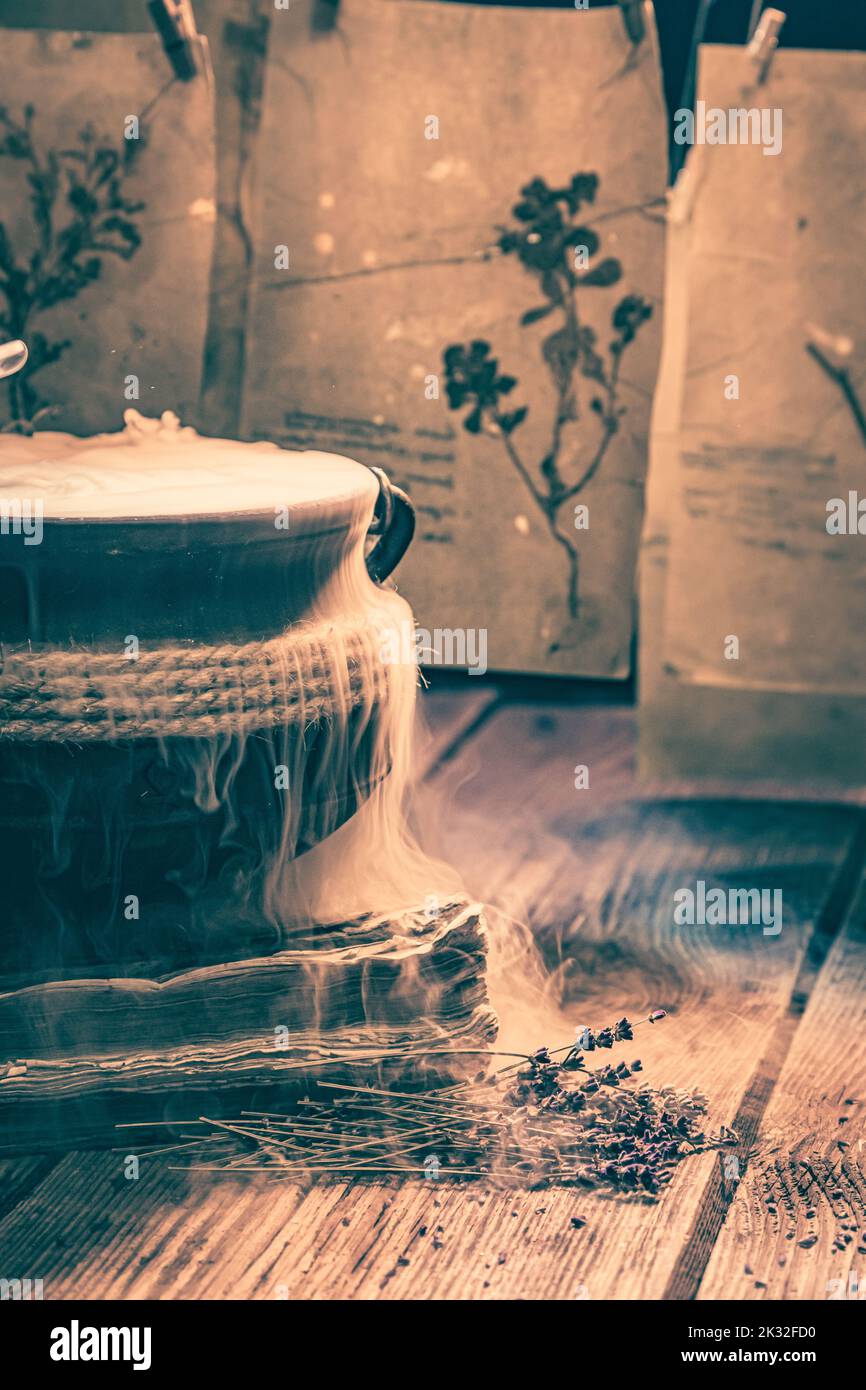 Spooky witcher cauldron with flowing smoke. For halloween background ...