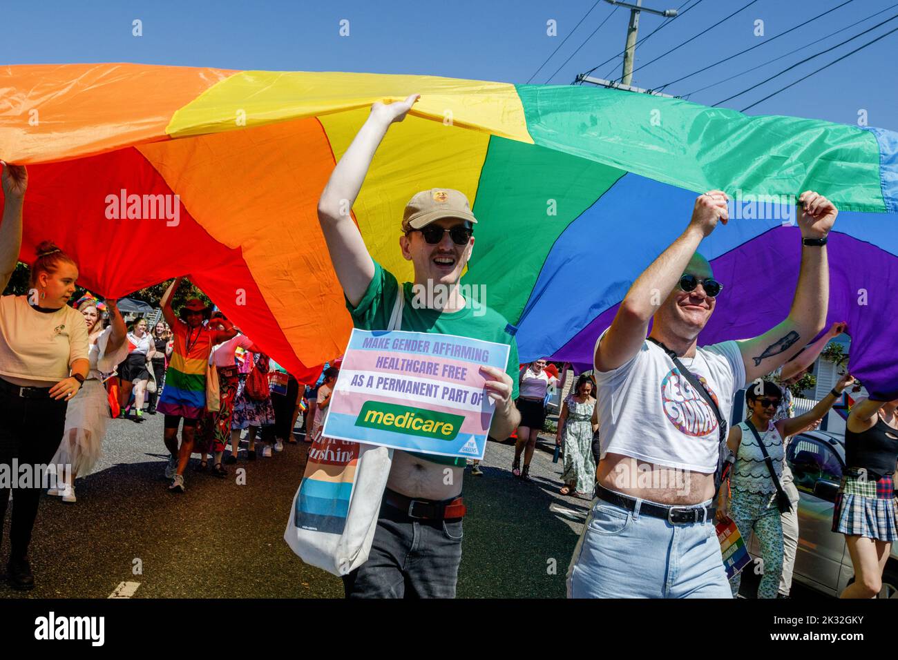 Brisbane, Australia. 24th Sep, 2022. Marchers carry a giant rainbow ...