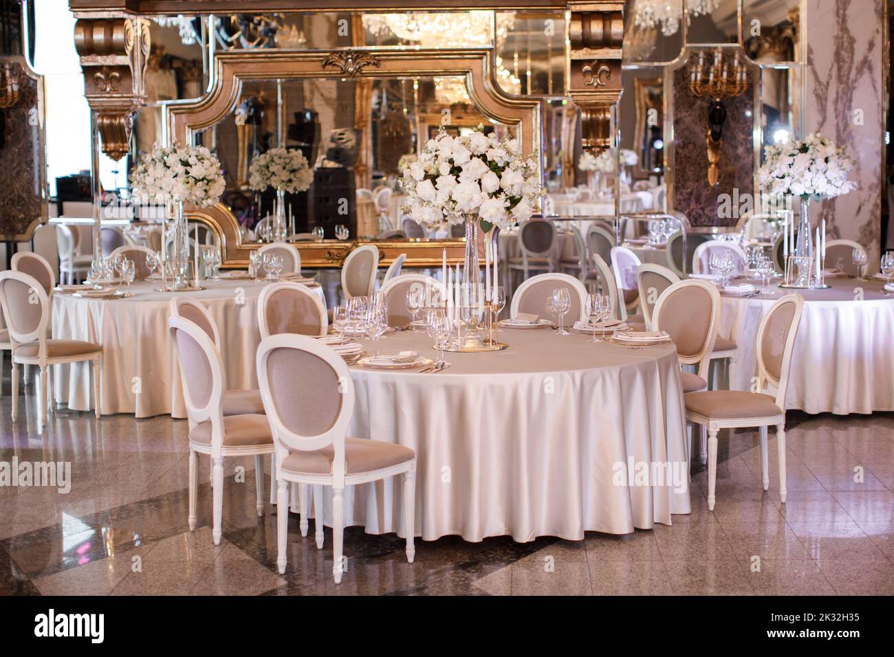 Tables setting at a luxury wedding. Table for guests. Dishes and drinks ...