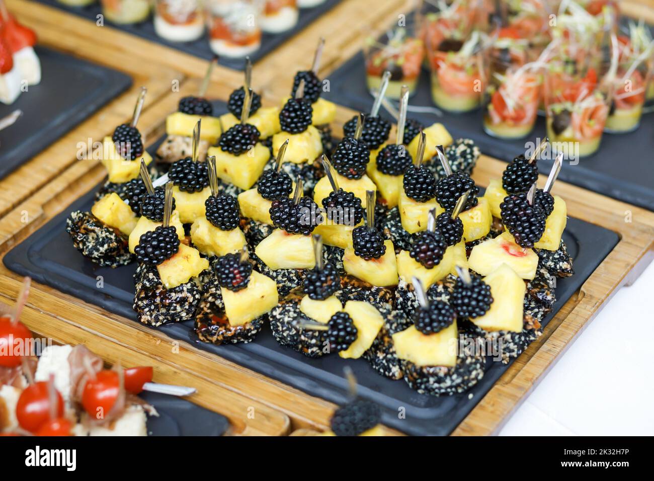 Waiter carrying plates with snack dishes on some festive event, party ...